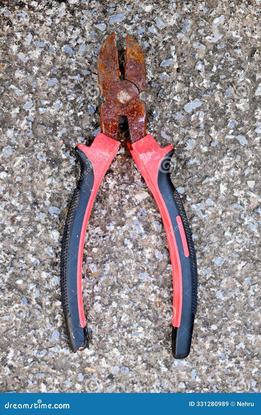 A Rusty Pliers with a Red Handle on a Concrete Stock Image - Image of ...