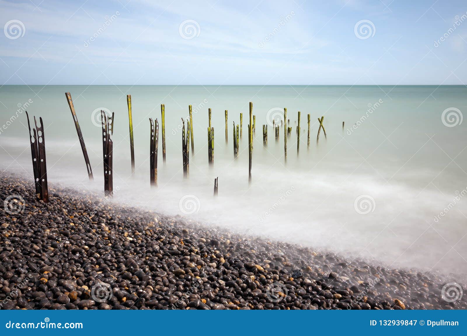 Rusty Posts on Beach stock image. Image of shore, stone - 132939847
