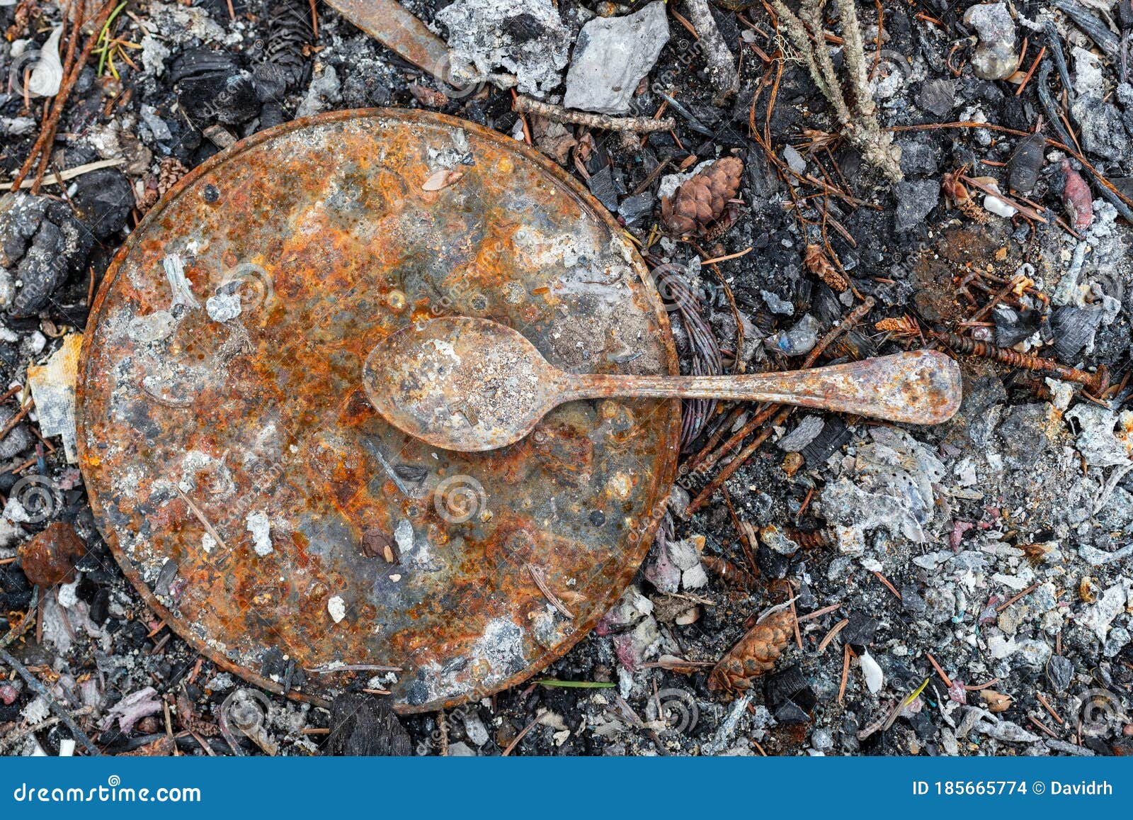 Rusty Spoon and Metal Plate on the Ground after a Fire Stock Photo ...
