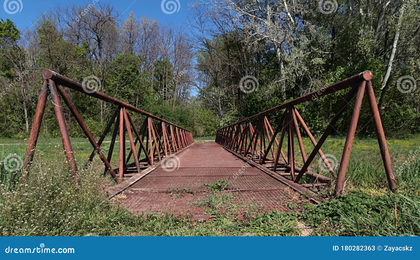 Rusty Pedestrian Bridge with Grate Floor As Pathway Across Artificial ...