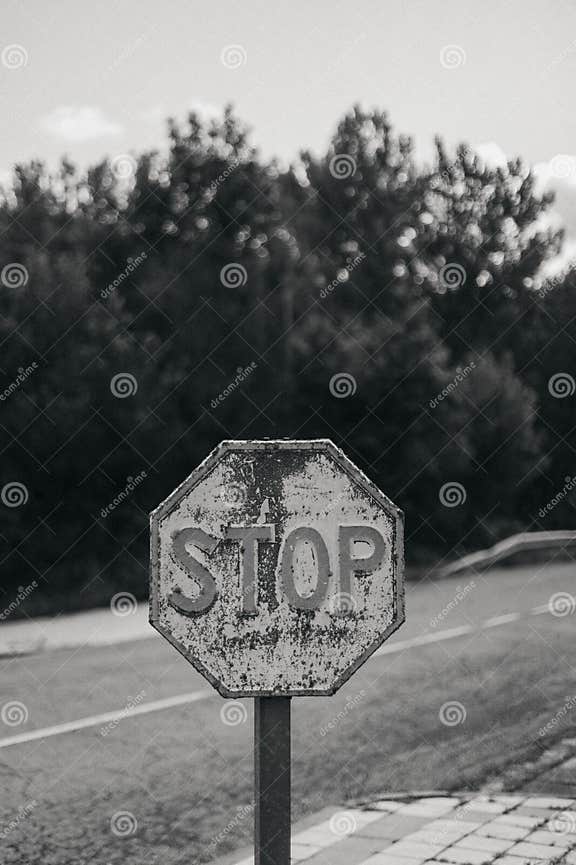 Rusty Stop Sign on the Road in Black and White Stock Photo - Image of ...