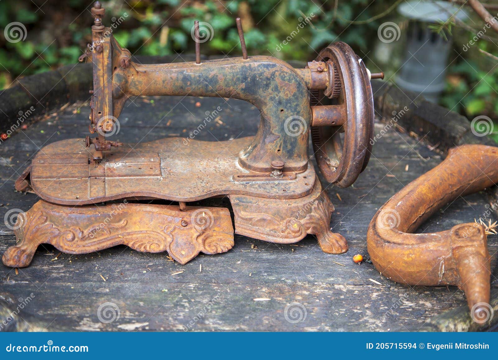 Rusty Vintage Sewing Machine on a Wooden Table in the Garden Stock ...