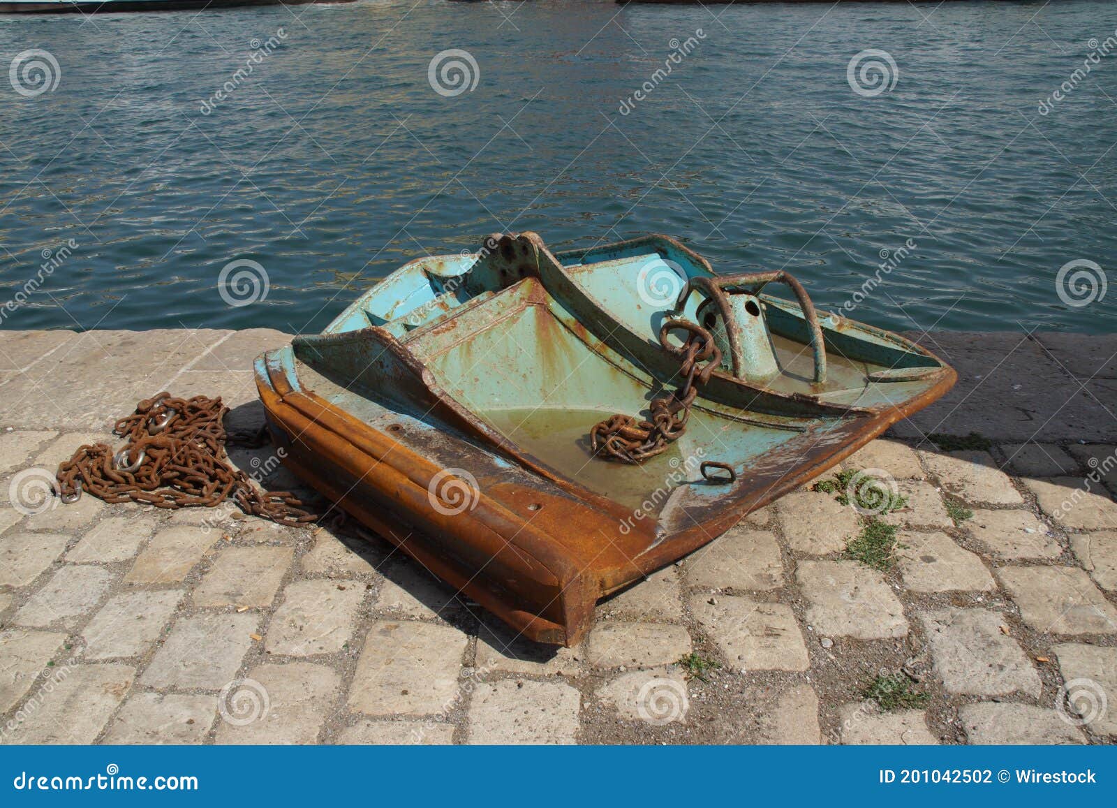 Rusty and Weathered Metallic Object of a Boat on the Ground in Front of ...