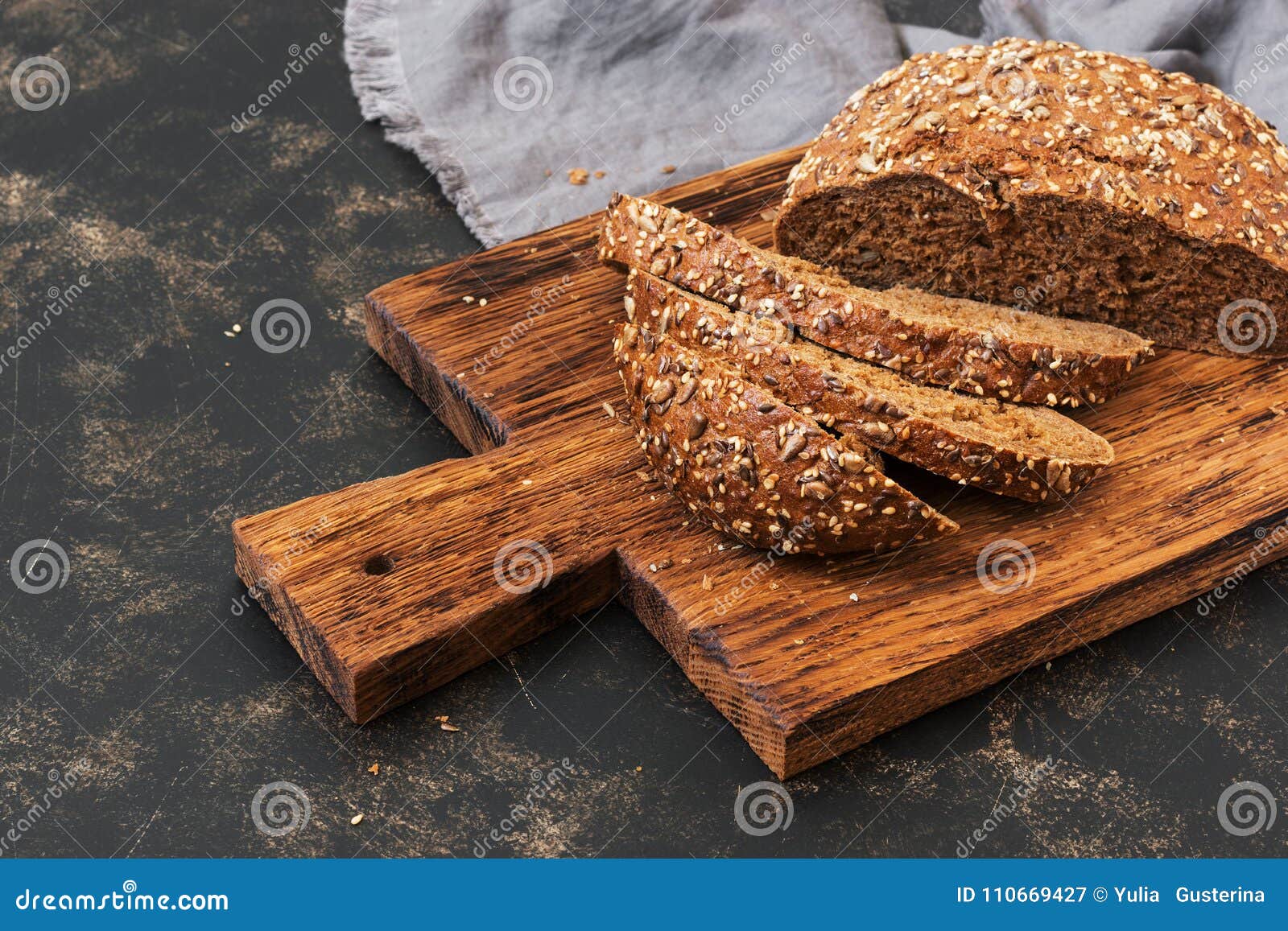 Rye Fresh Bread with Grains Chopped on a Cutting Board. Stock Image ...