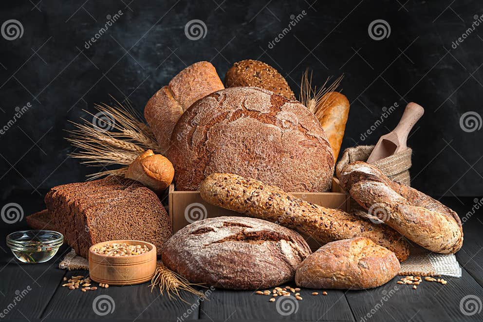 Rye and Wheat Bread of Different Types on a Dark Background. Stock ...