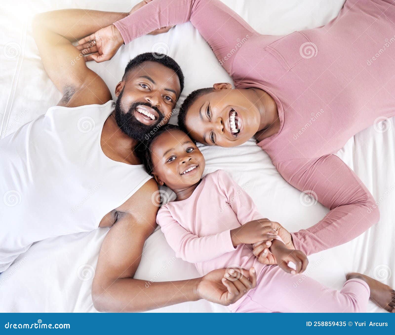 The Sacred Magic of Family. a Young Family Bonding in Bed Together ...