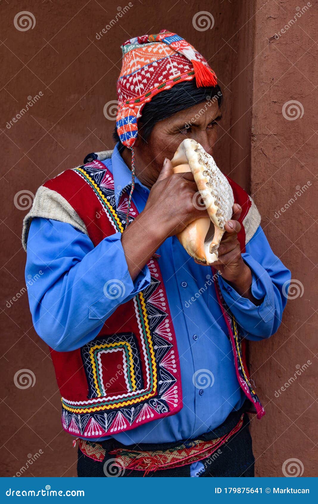 An Indigenous Quechua Man Blows on a Conch Shell. Cusco, Peru Editorial ...