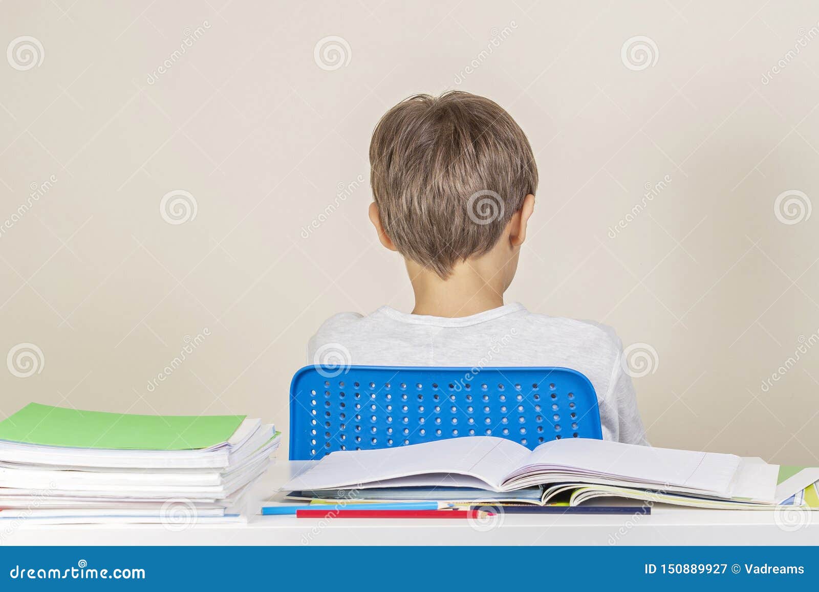 Sad Alone Kid Sitting Turn Back at the Table with Pile of School Books ...
