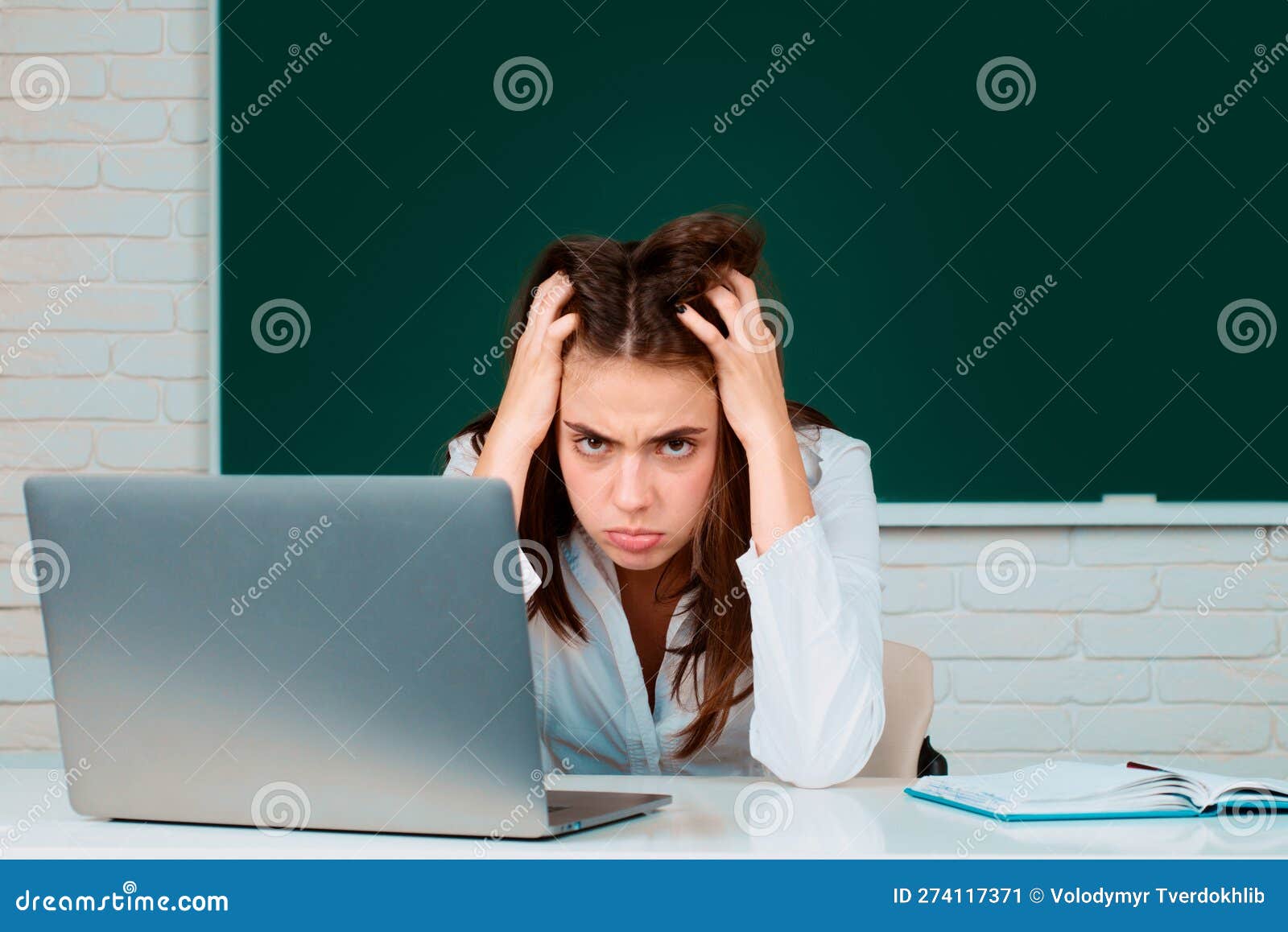 Sad and Angry Student Using Computer in Classroom. Stock Image - Image ...