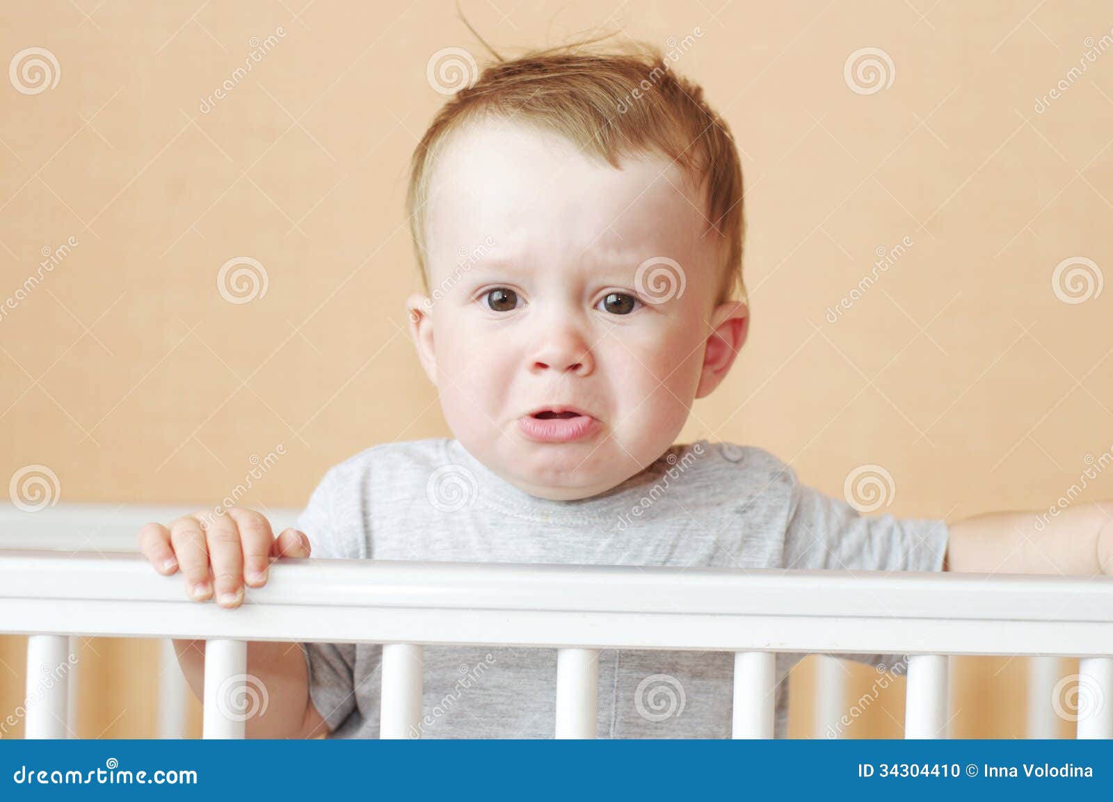 Sad baby in white bed stock photo. Image of baby, tear - 34304410