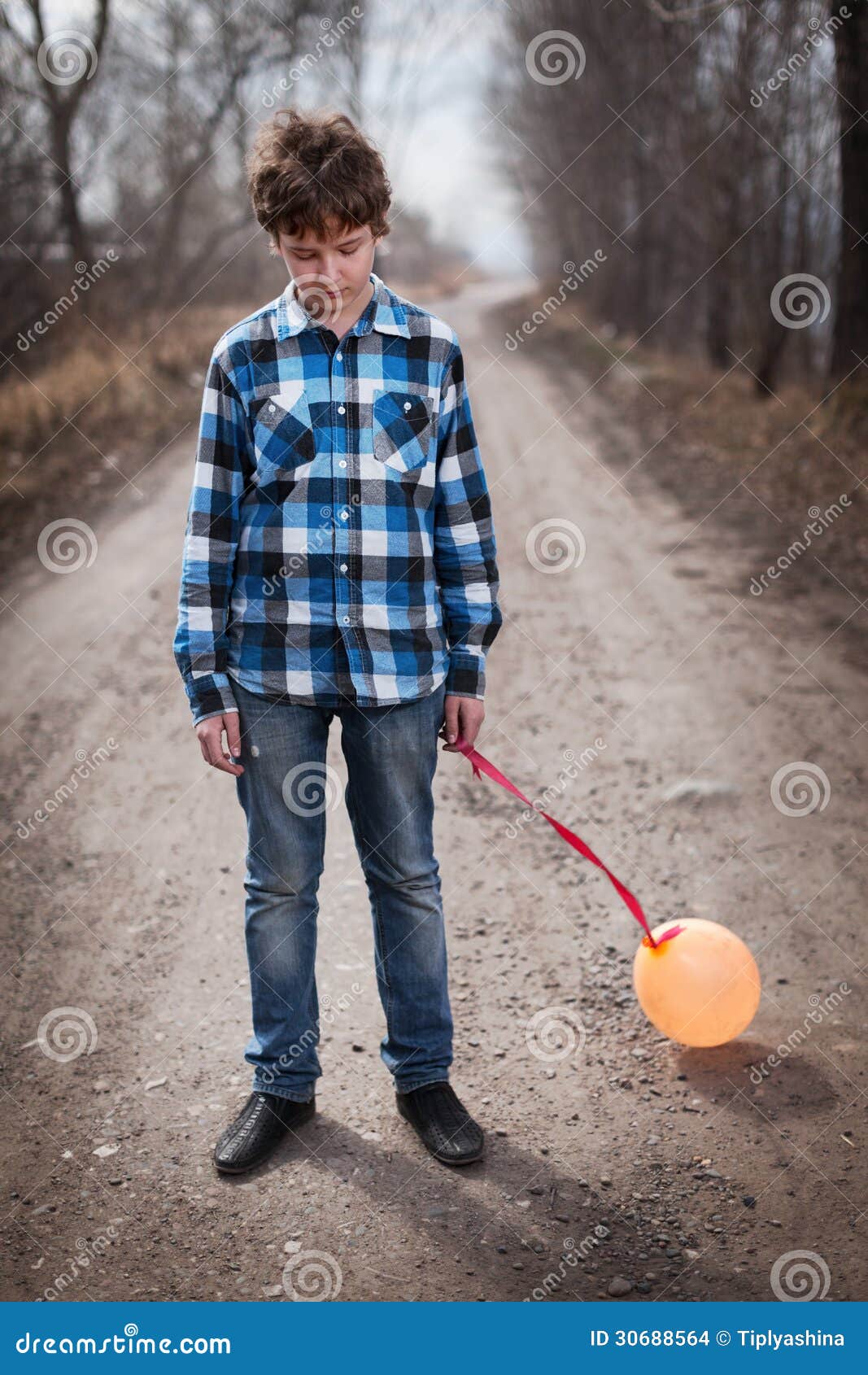 The sad boy with a balloon stock photo. Image of orange - 30688564