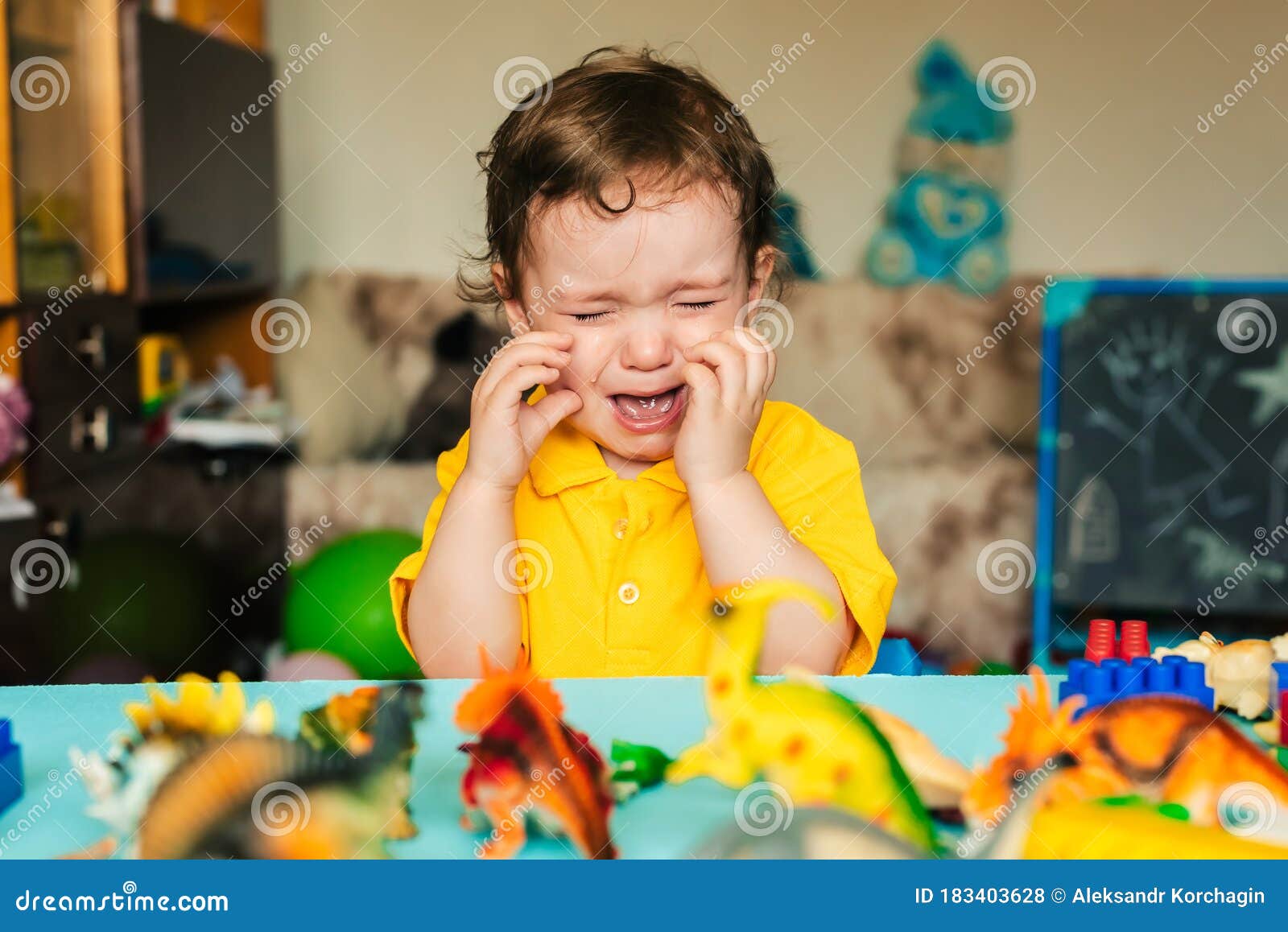 Sad Boy Cries Next To Toy Dinosaurs Stock Photo - Image of expression ...