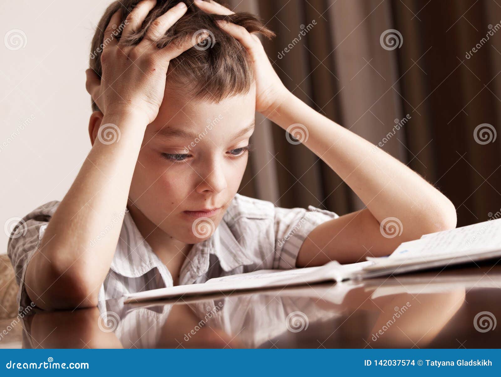 Sad boy doing homework stock photo. Image of difficult - 142037574