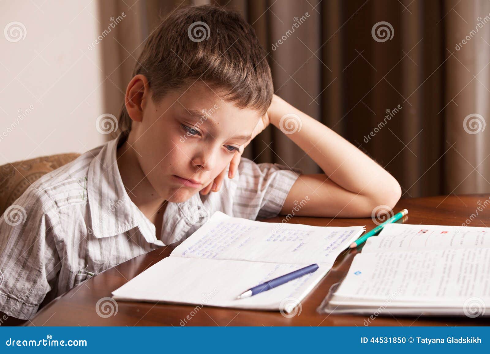 Sad boy doing homework stock photo. Image of book, child - 44531850
