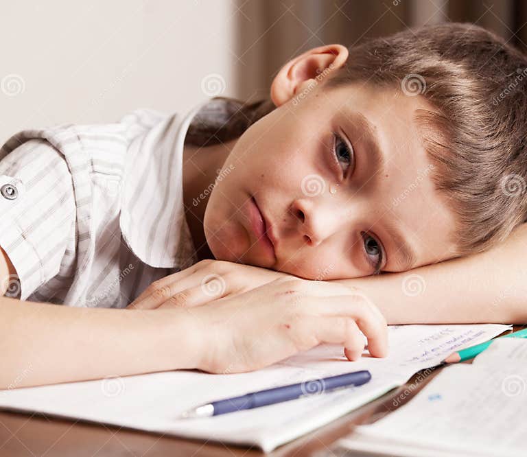 Sad boy doing homework stock photo. Image of problem - 44531744