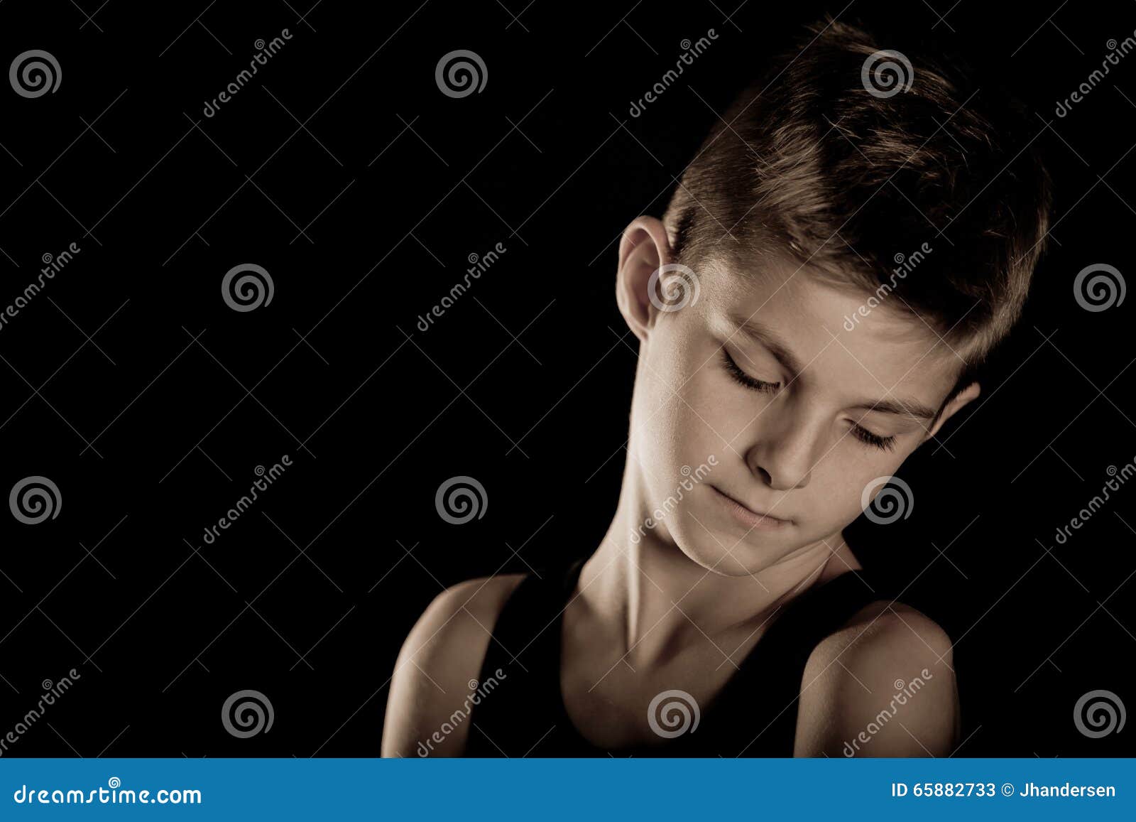 Sad Boy Looking Down Against Black with Copy Space Stock Image - Image ...