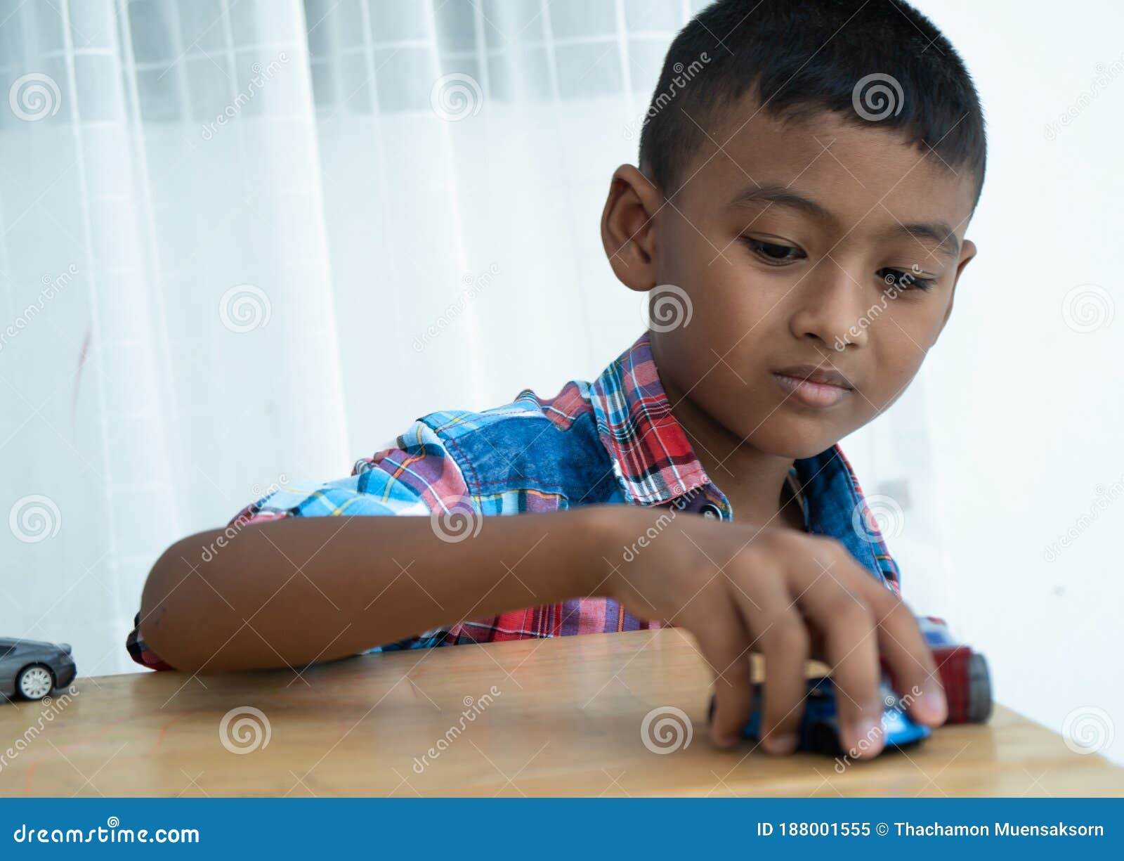Sad Little Boy Lying on the Table and Play Toy Car Stock Image - Image ...