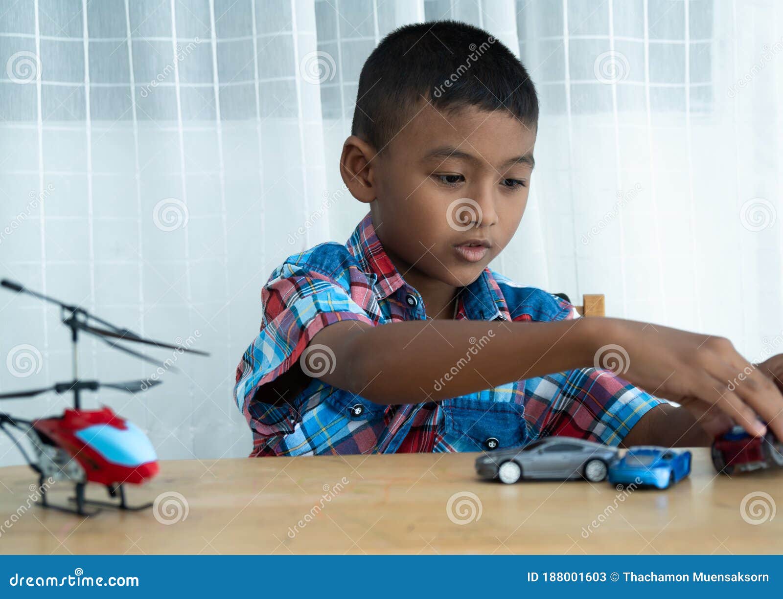Sad Little Boy Lying on the Table and Play Toy Car Stock Image - Image ...