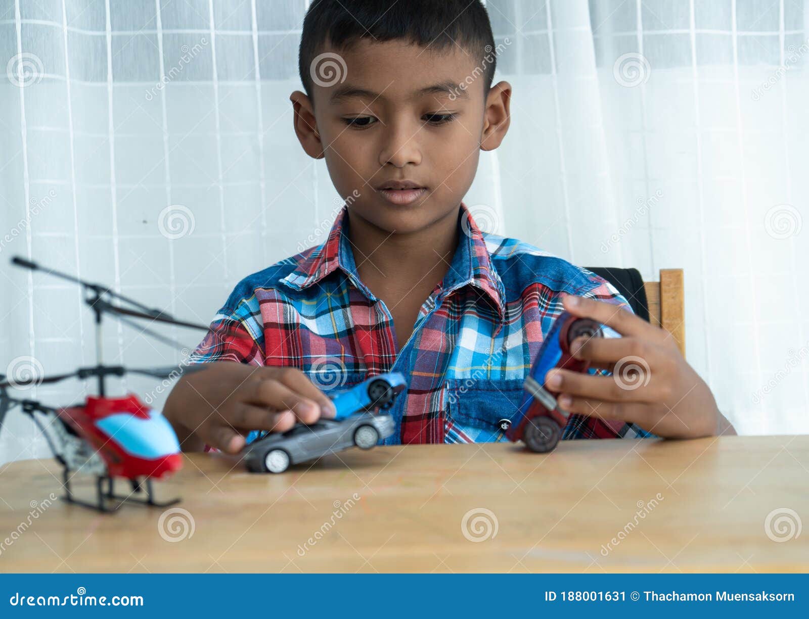 Sad Little Boy Lying on the Table and Play Toy Car Stock Image - Image ...