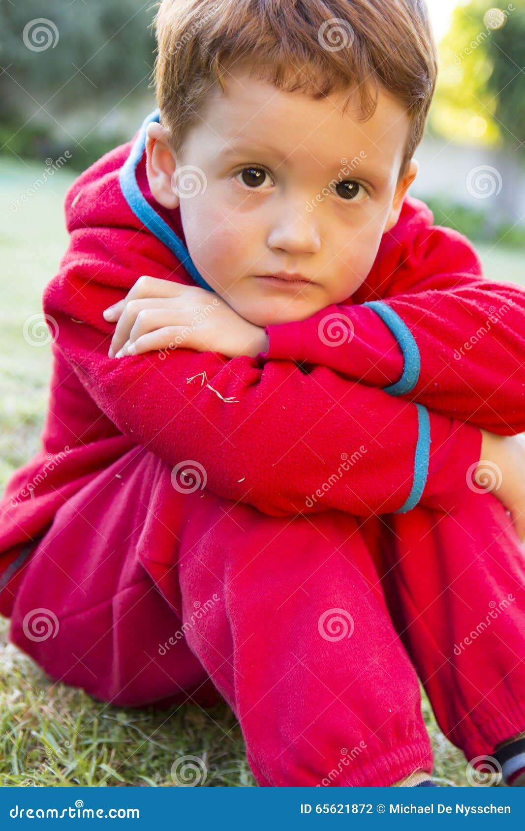 Sad boy outside on lawn stock photo. Image of disappointed - 65621872