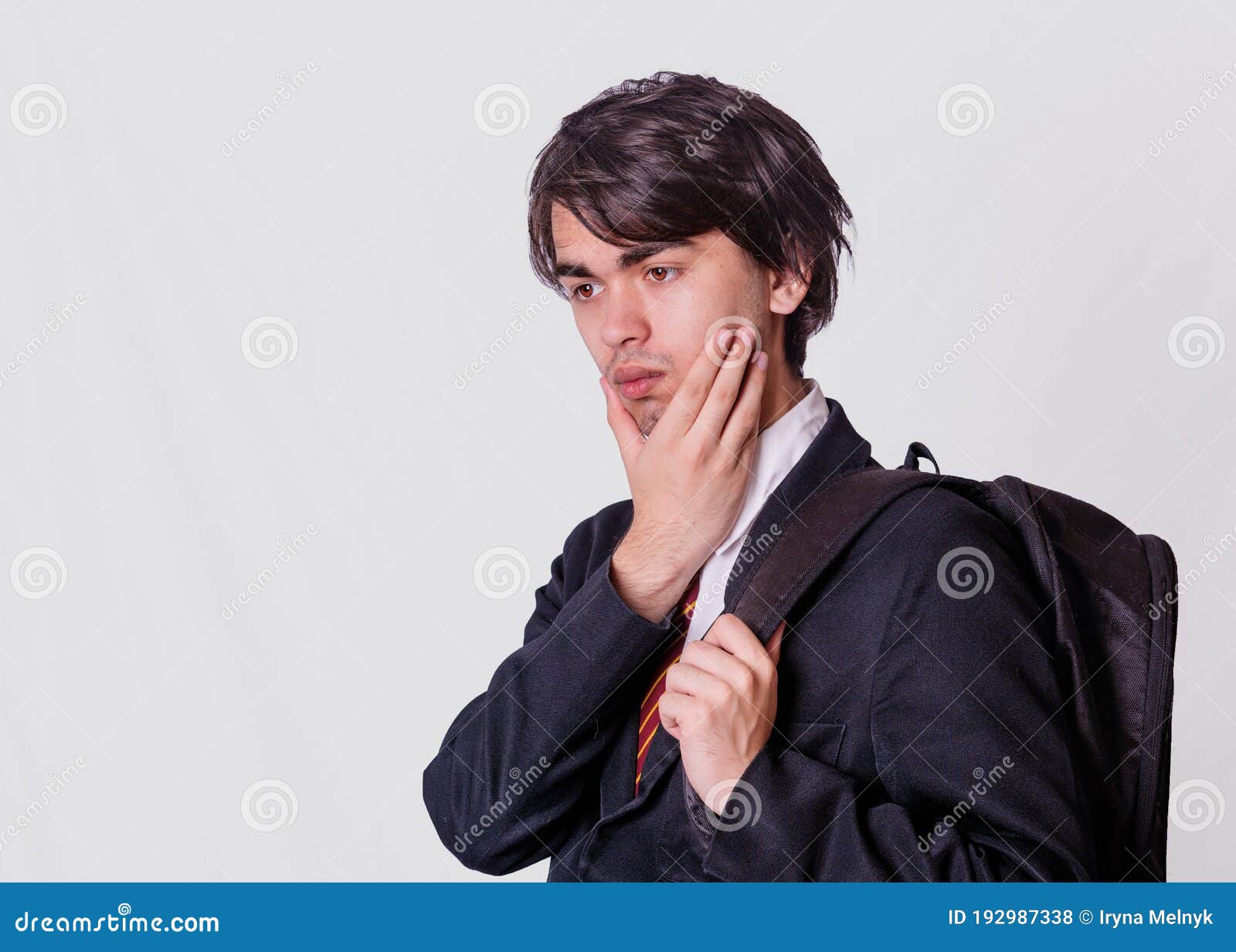 Sad Boy in a School Suit and with a Backpack Going Back To School Stock ...