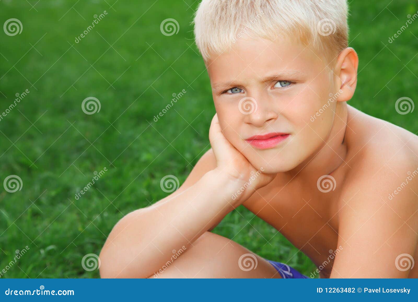 Sad boy sitting on meadow stock photo. Image of happy - 12263482
