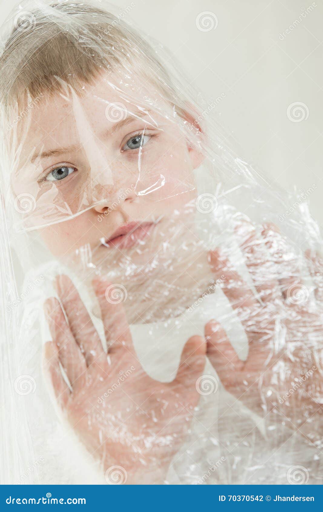Sad boy wrapped in plastic stock photo. Image of lonely - 70370542