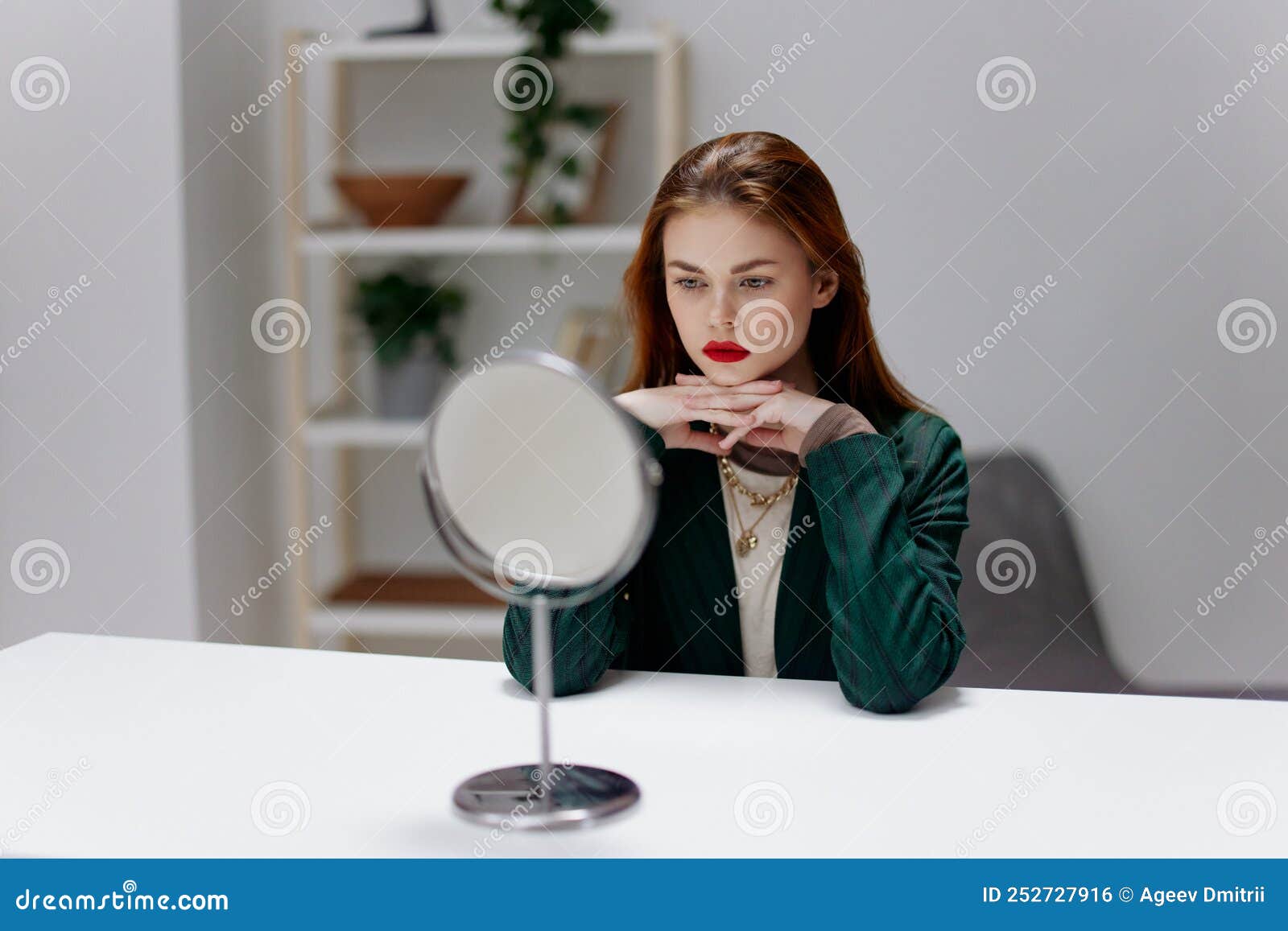 A Sad, Brooding, Tired Young Red-haired Woman at the Table is Thinking ...