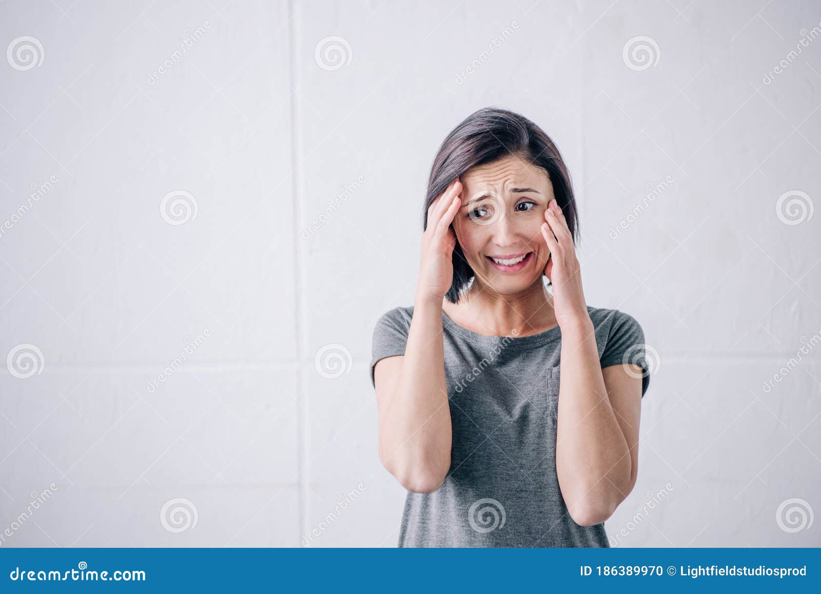 Brunette Woman with Hands on Head Crying at Home Stock Photo - Image of ...