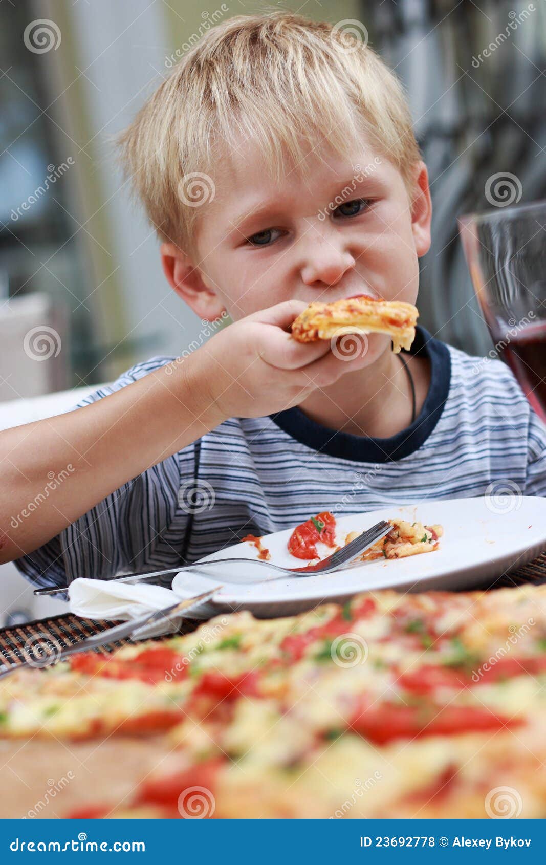 Sad Child eating pizza. stock photo. Image of lunch, enjoyment - 23692778
