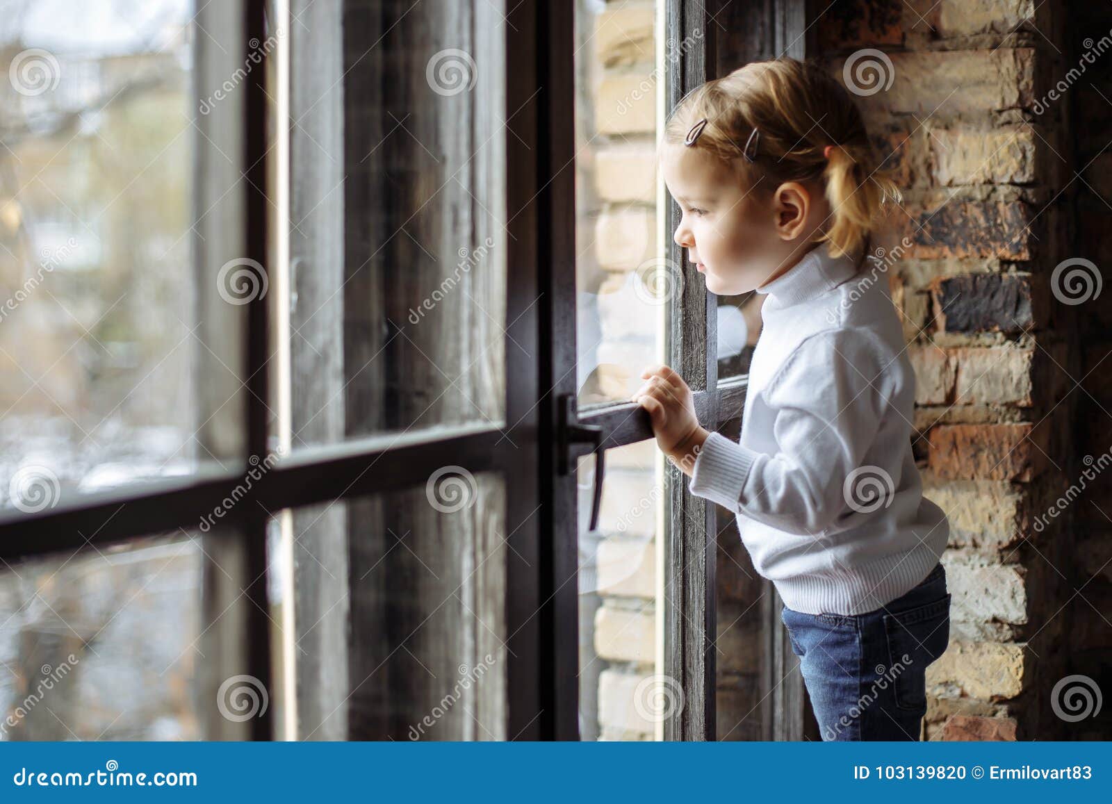 Child Looking Out A Window