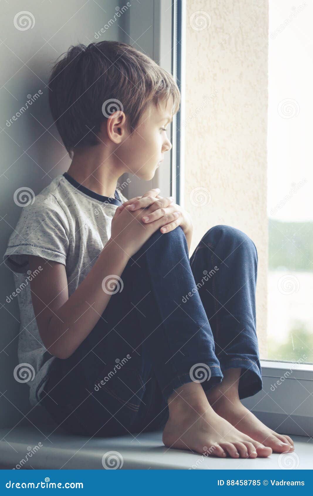 Sad Child Sitting on Window Shield and Looking Out the Window Stock ...