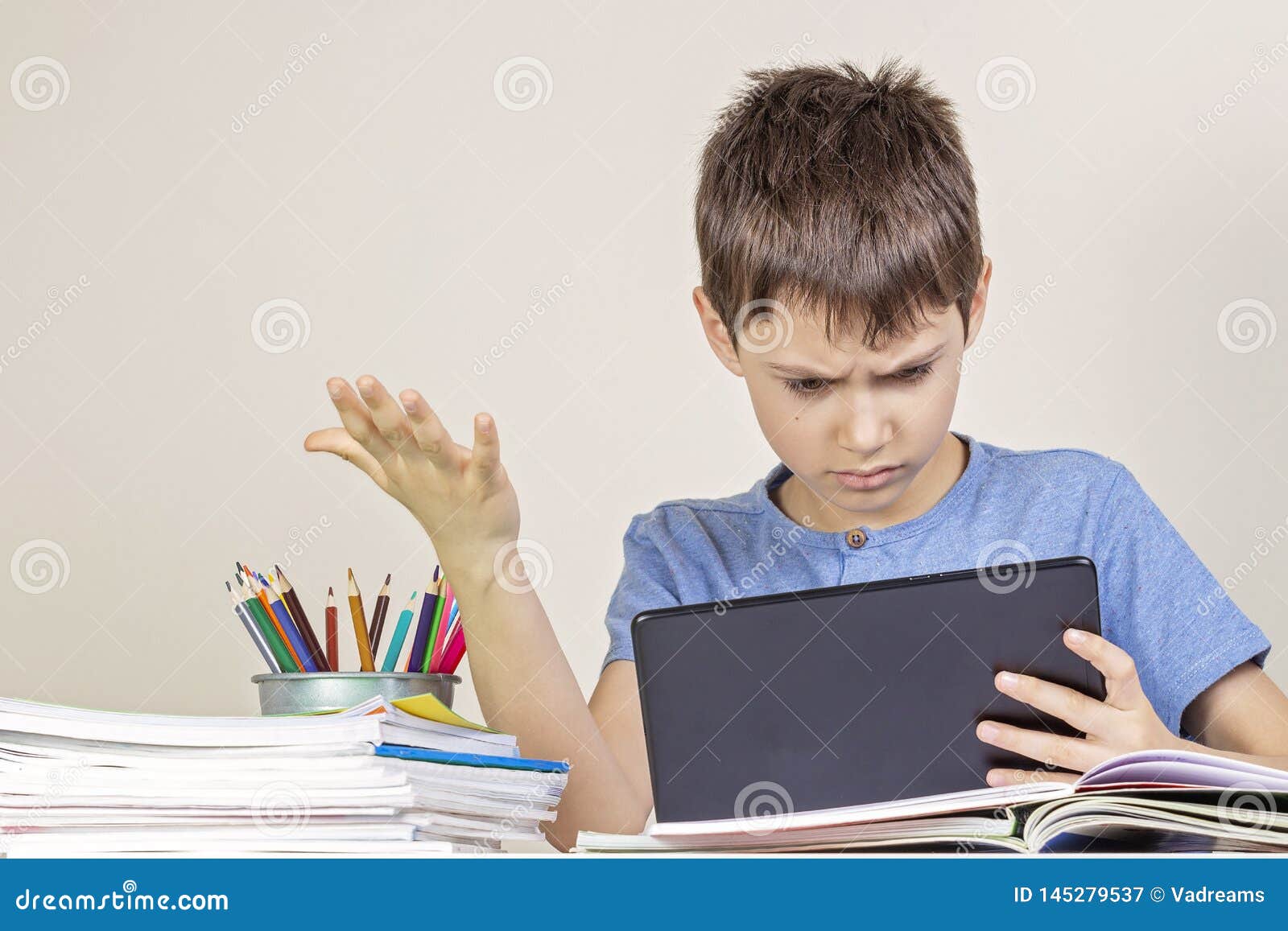 Sad, Confused,surprised Child with Tablet Computer Sitting at Table ...