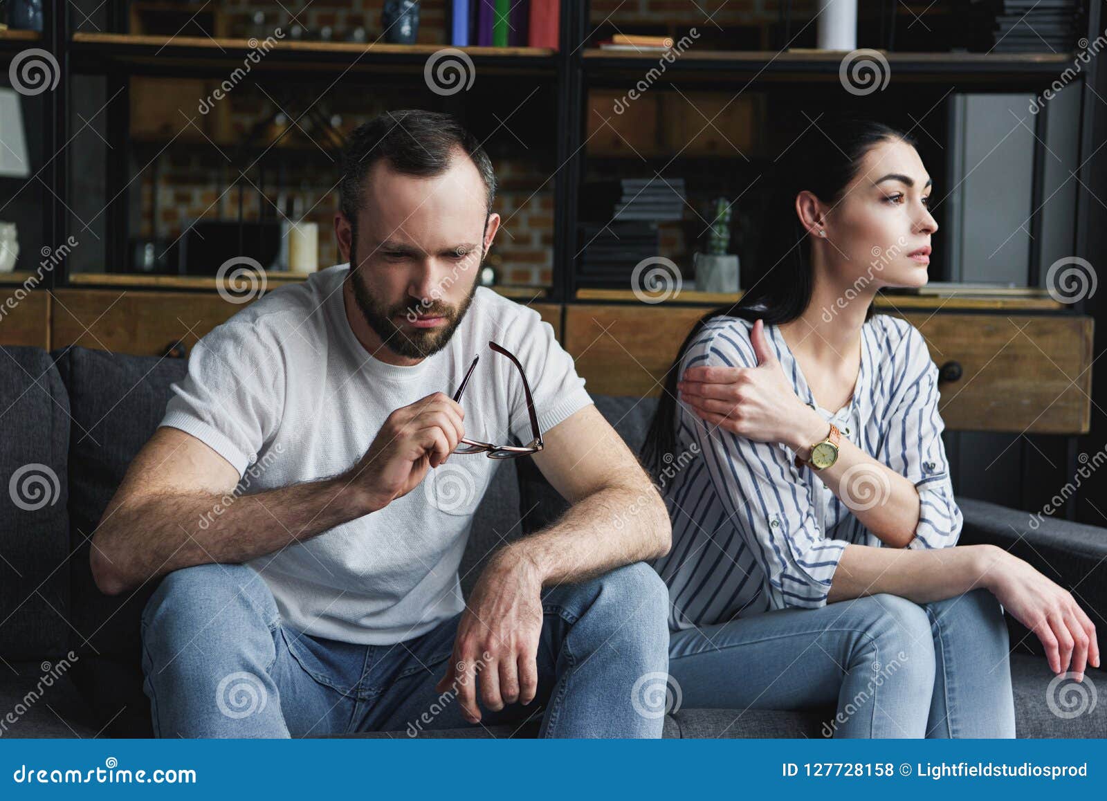 Sad Couple Sitting on Sofa at Home after Quarrel Stock Photo - Image of ...