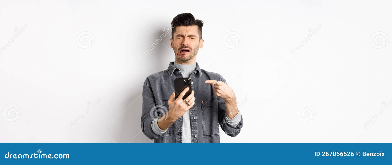 Sad Crying Guy Pointing at Smartphone and Sobbing, Complaining or ...