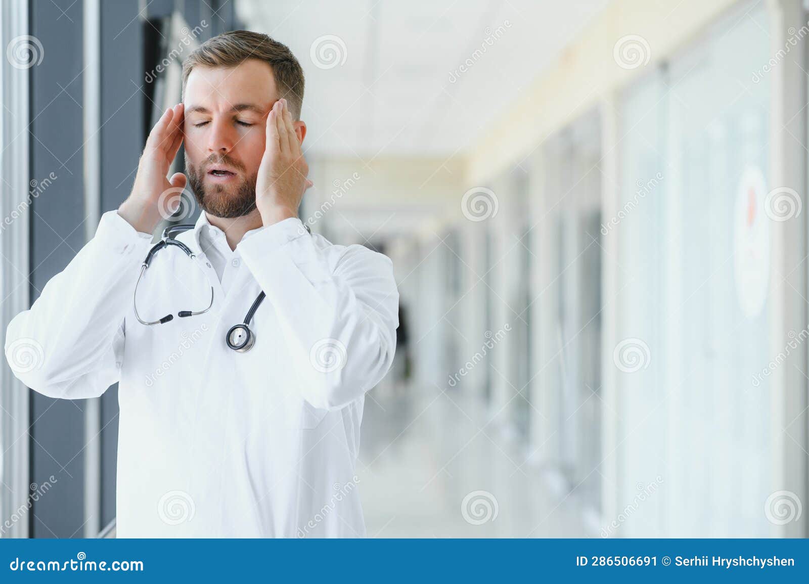 Sad Doctor Standing in Hospital Corridor Stock Image - Image of ...