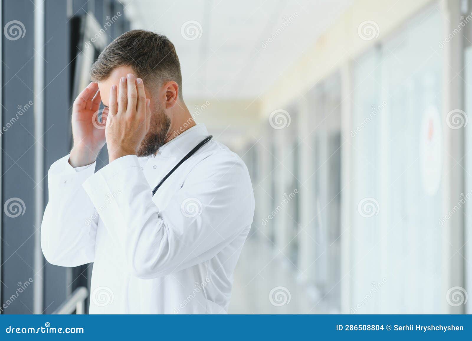 Sad Doctor Standing in Hospital Corridor Stock Photo - Image of ...