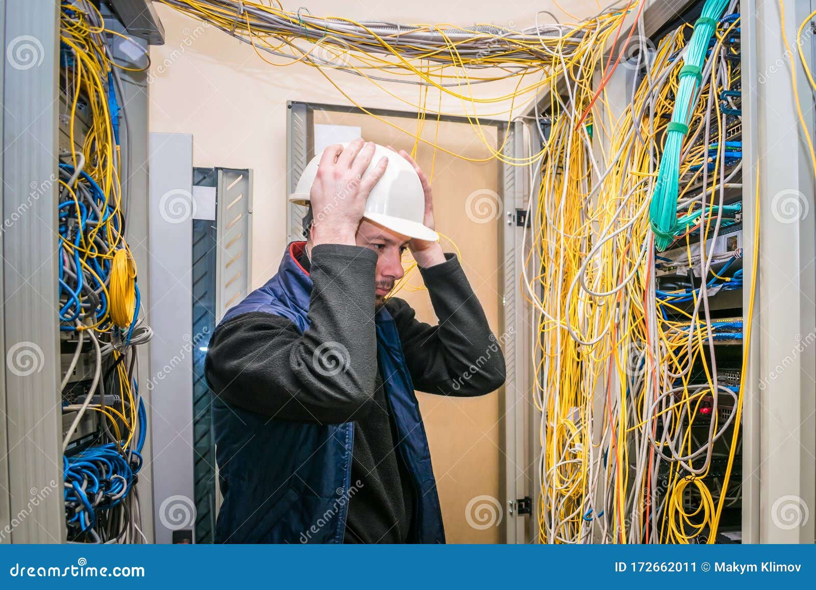 A Sad Engineer in a White Helmet Took Hold of His Head in His Hands ...