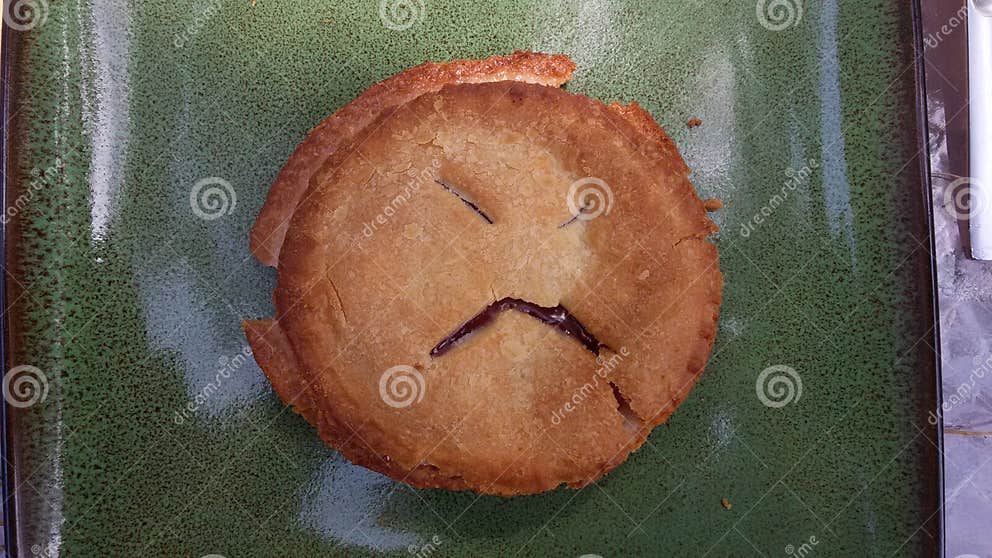 Sad Face in Mini Cherry Pie on a Green Plate Stock Photo - Image of ...
