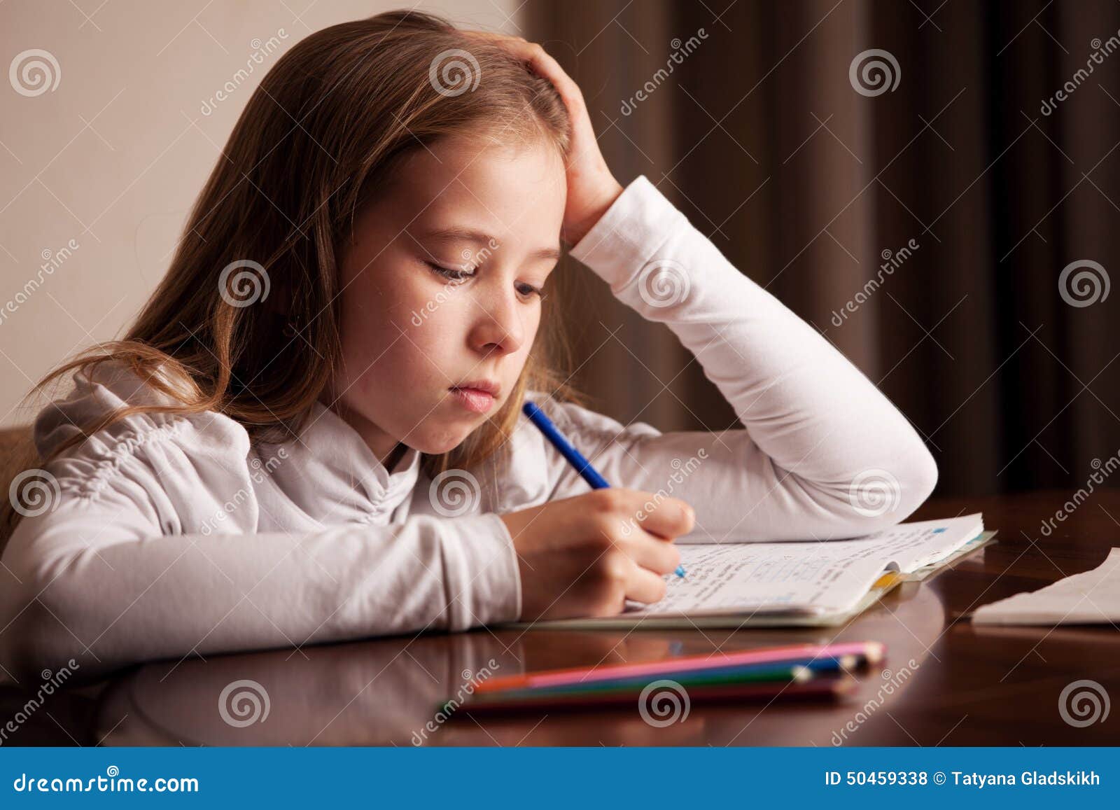 Sad girl doing homework stock photo. Image of expressing - 50459338