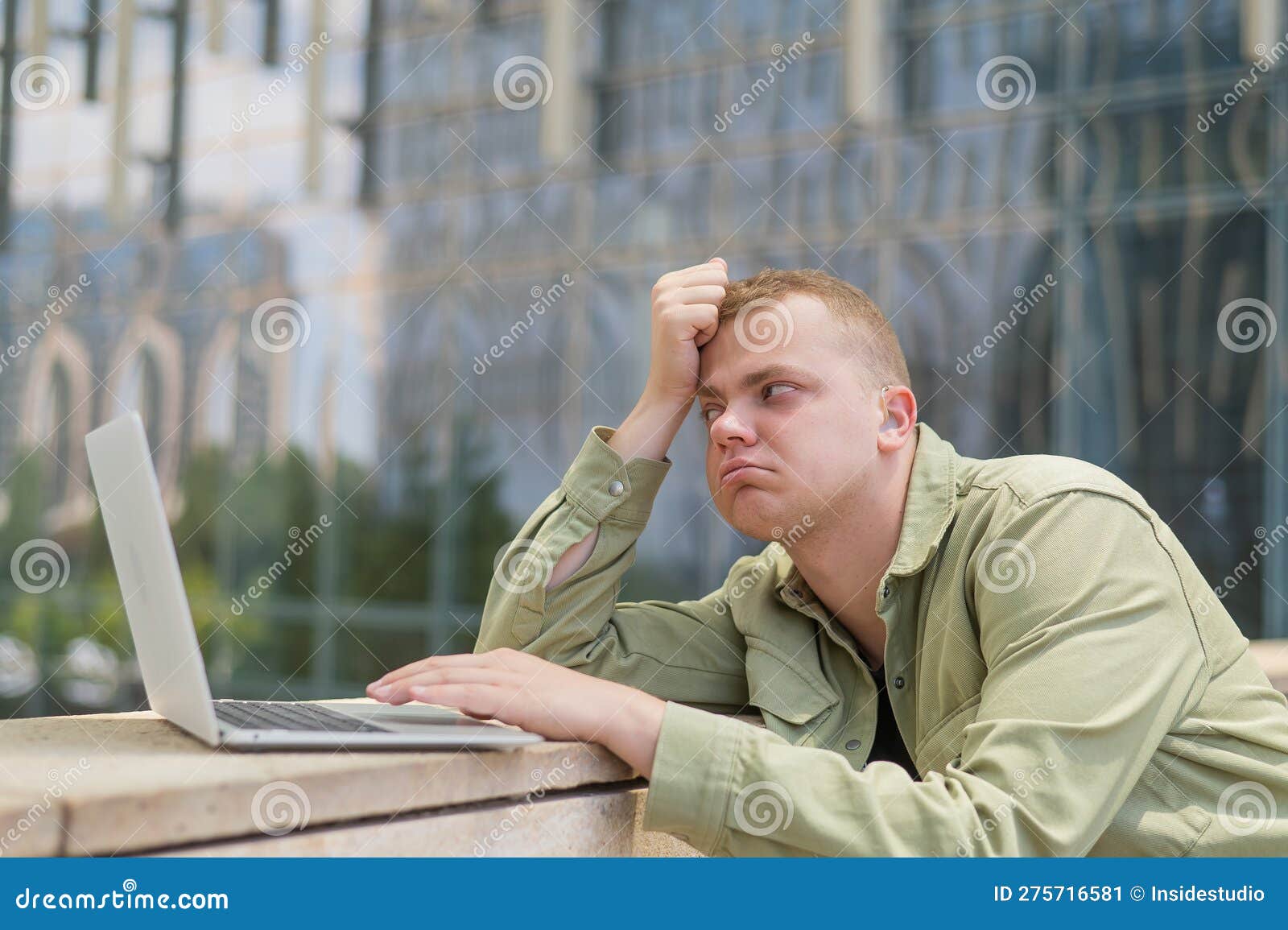Sad Guy with Hearing Aid Using Laptop Outdoors. Stock Image - Image of ...