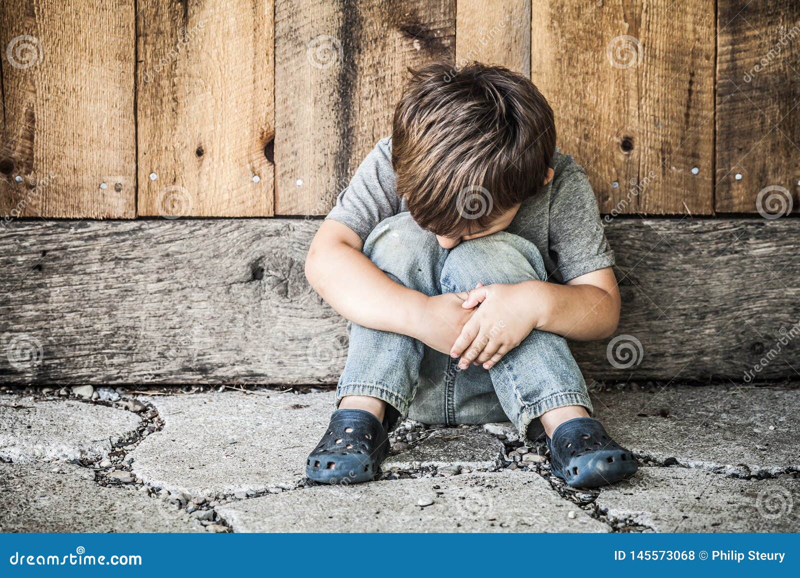 Sad Homeless Boy stock photo. Image of small, pain, hurt - 145573068