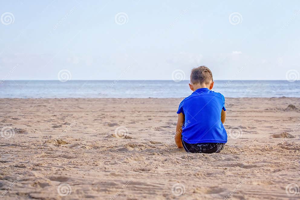 Sad Kid Sitting on Empty Beach Alone Stock Photo - Image of sand, ocean ...