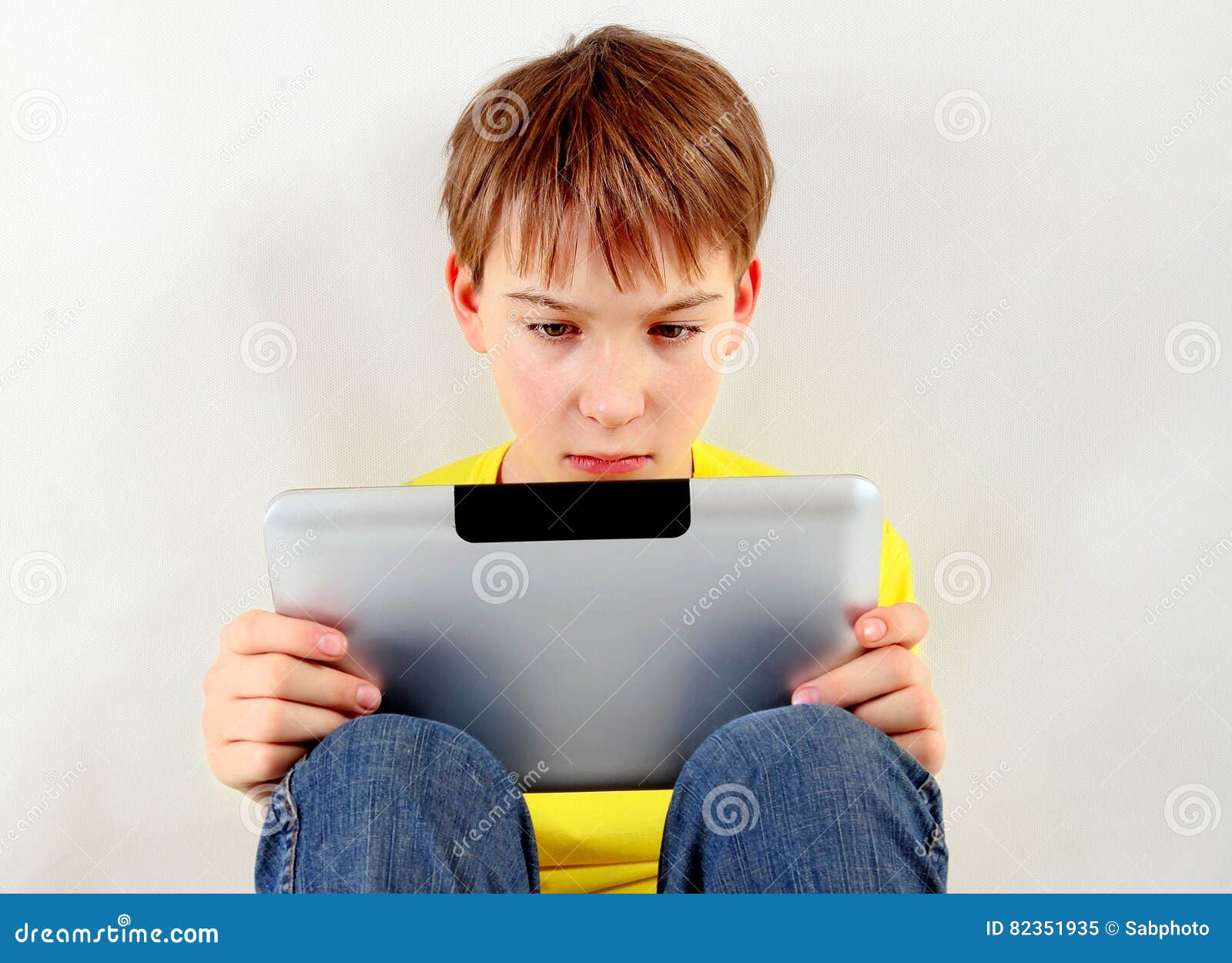 Sad Kid with Tablet stock image. Image of hands, device - 82351935