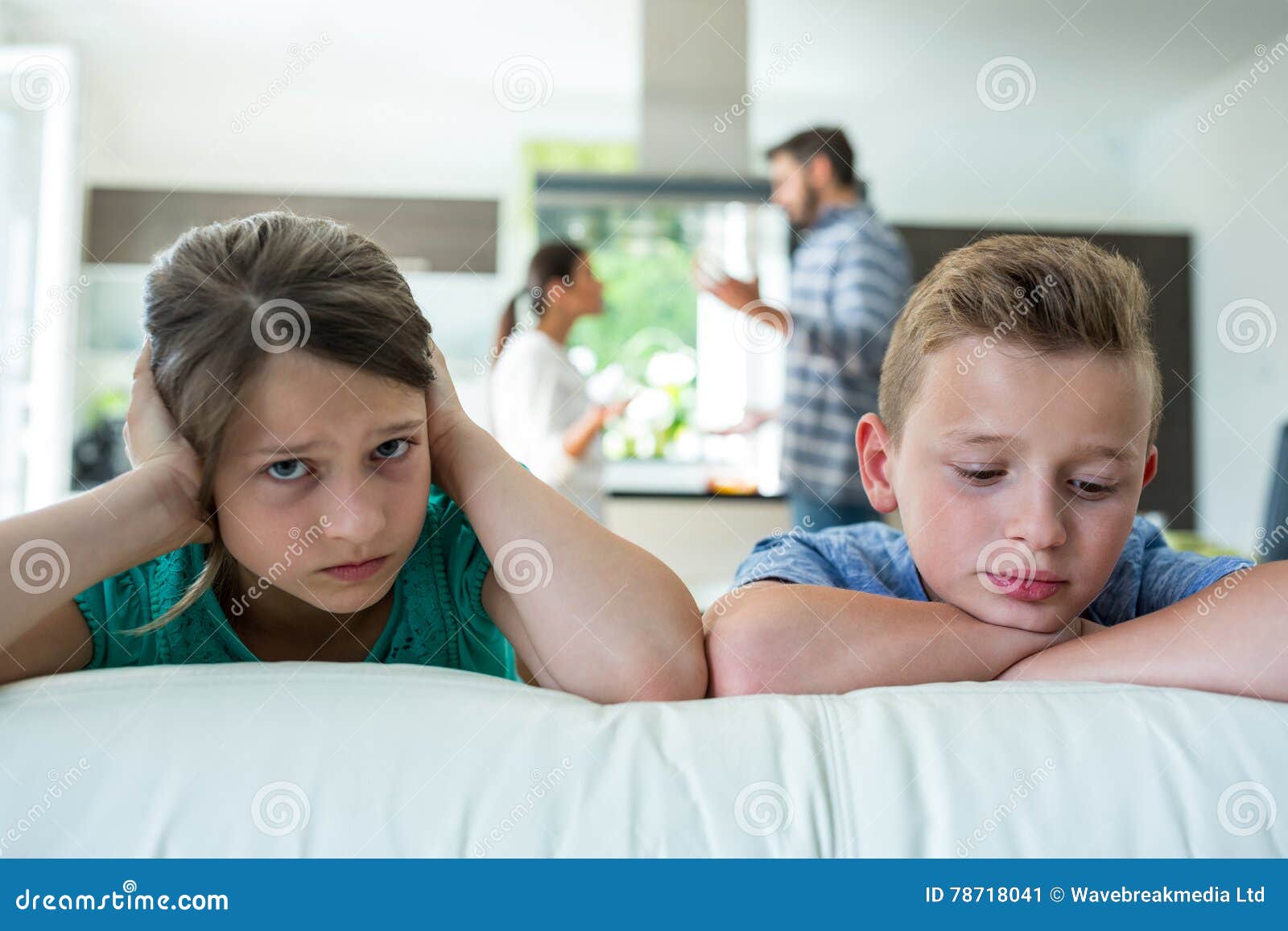 Sad Kids Leaning on Sofa while Parents Arguing in Background Stock ...