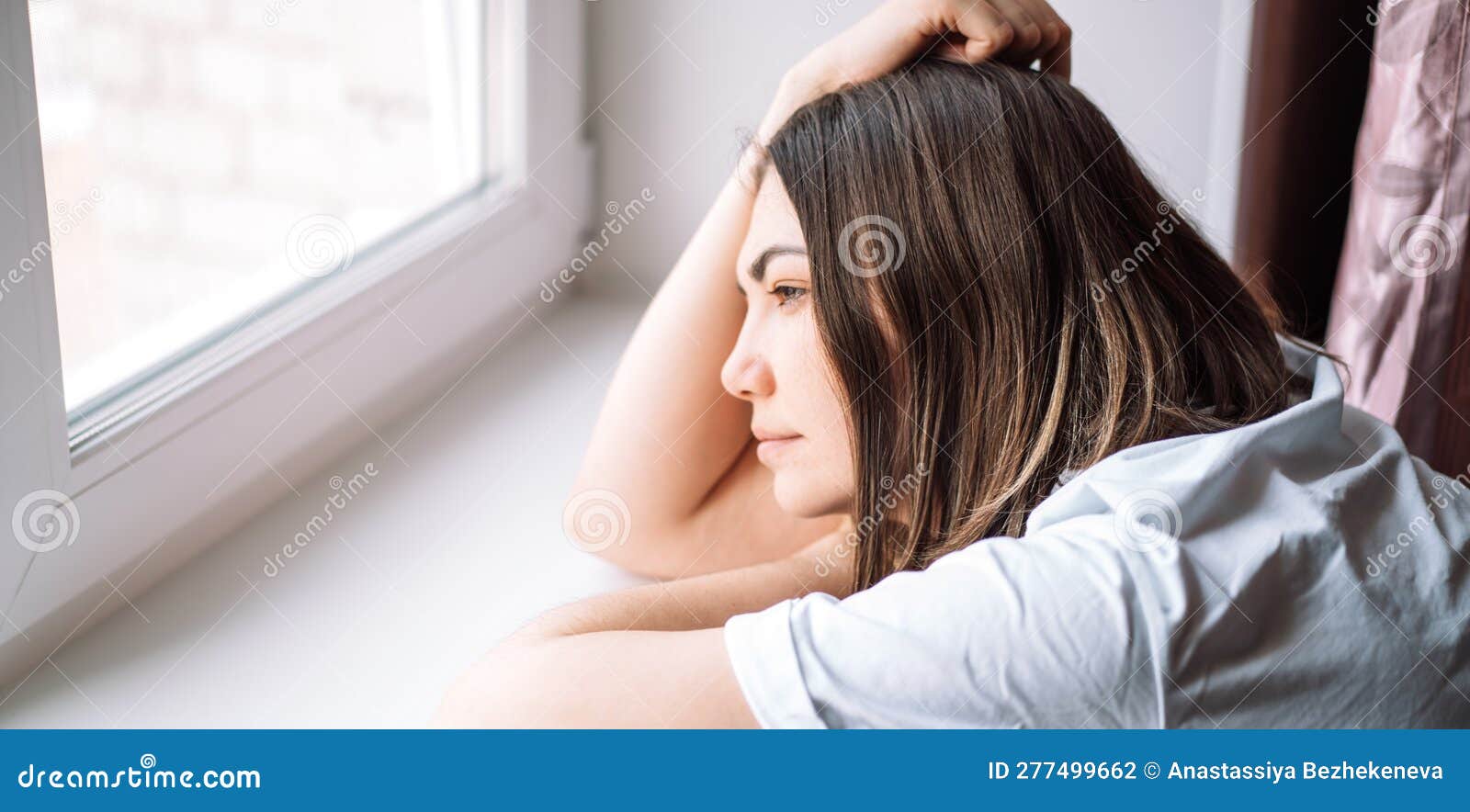 Sad Lady Lay Down on the Windowsill and Looks Out the Window Stock ...