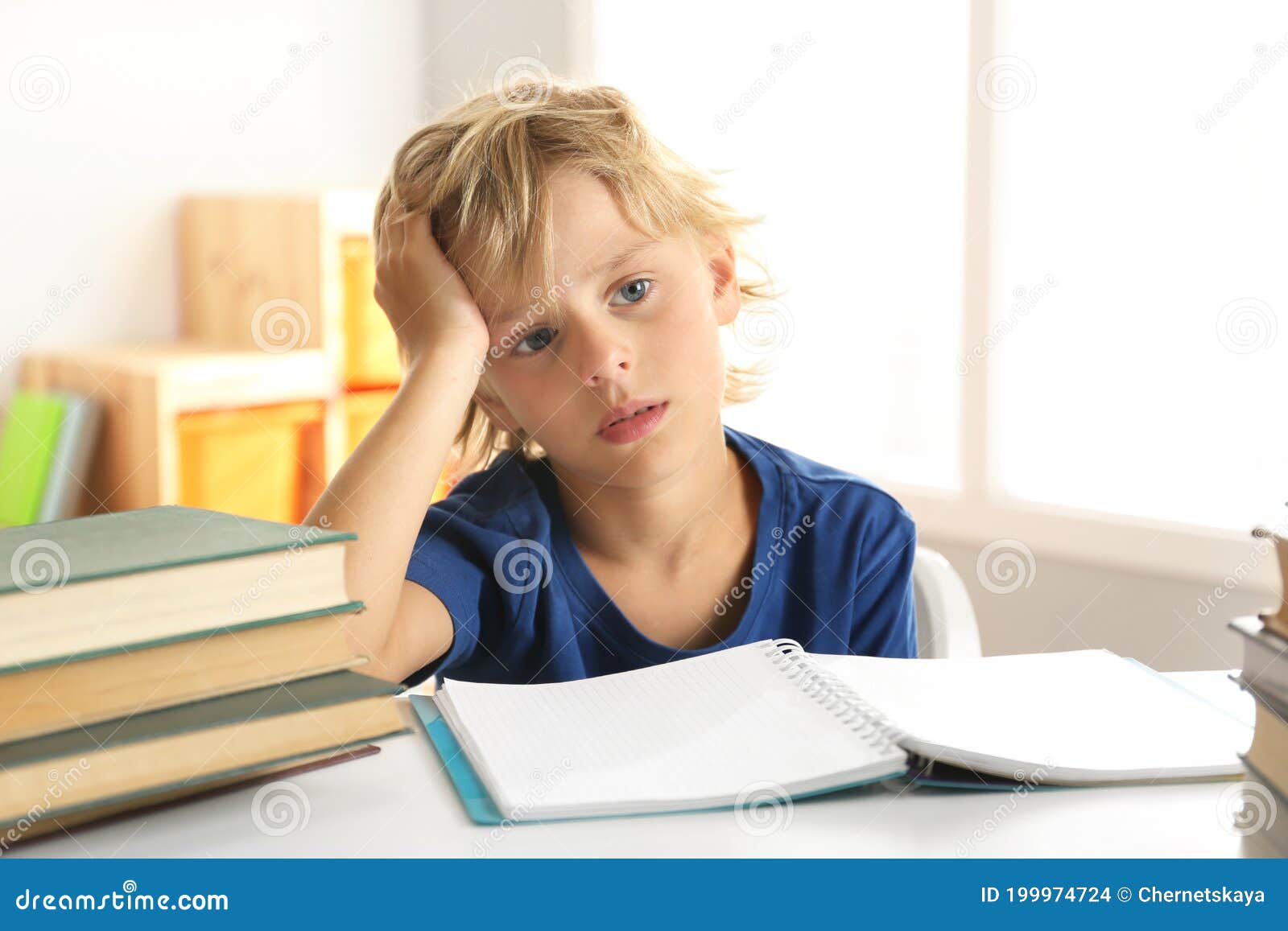 Sad Little Boy Doing Homework at Table Indoors Stock Photo - Image of ...