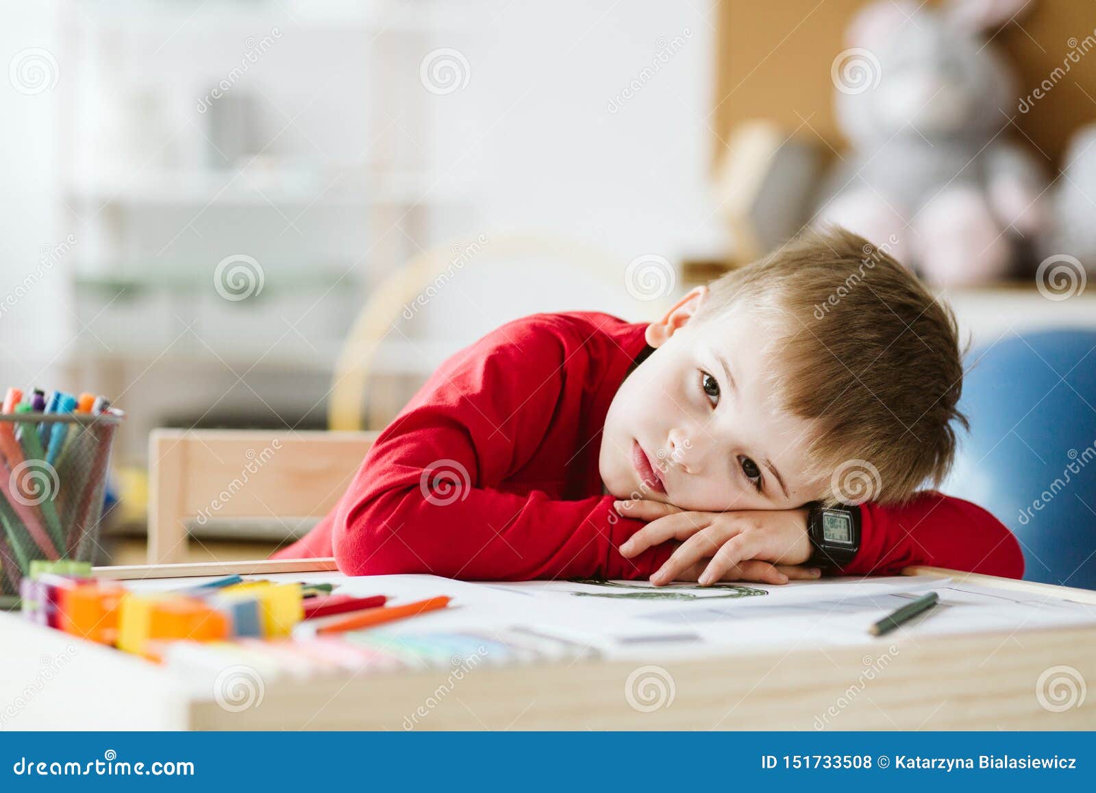 Sad Little Boy in Red Sweater Feeling Lonely and Lying on a Table Stock ...