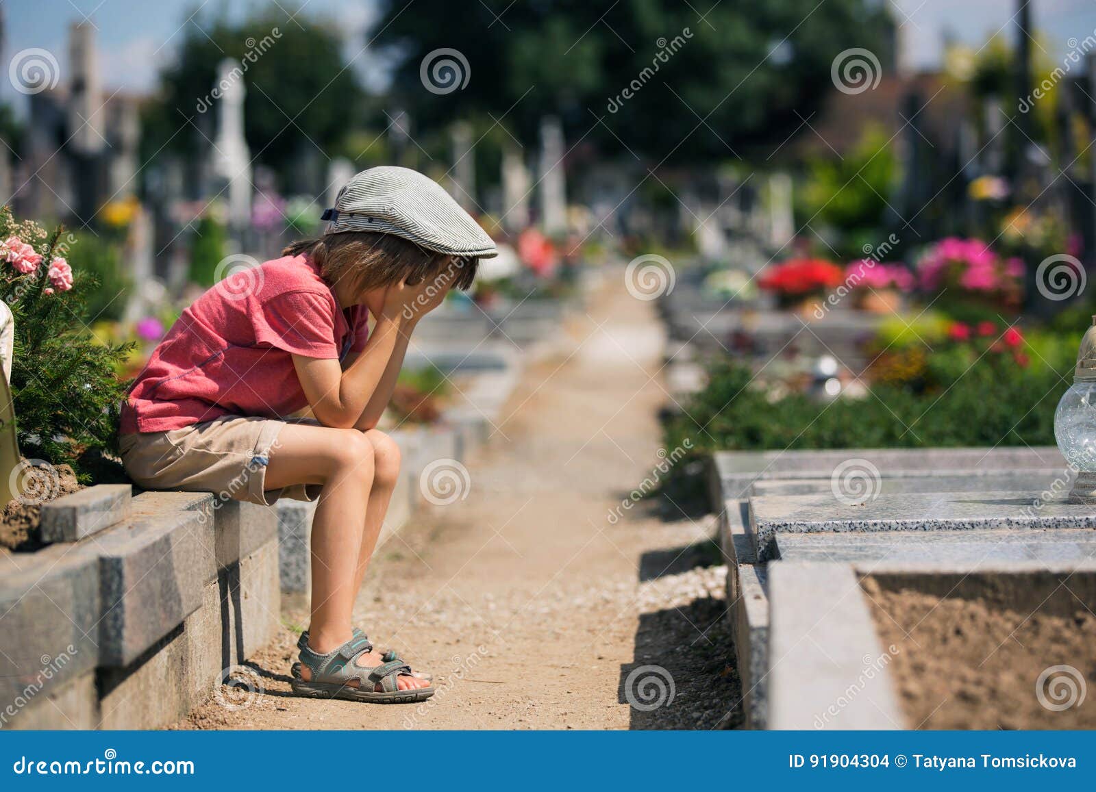 Sad Little Boy, Sitting on a Grave in a Cemetery, Feeling Sad Stock ...