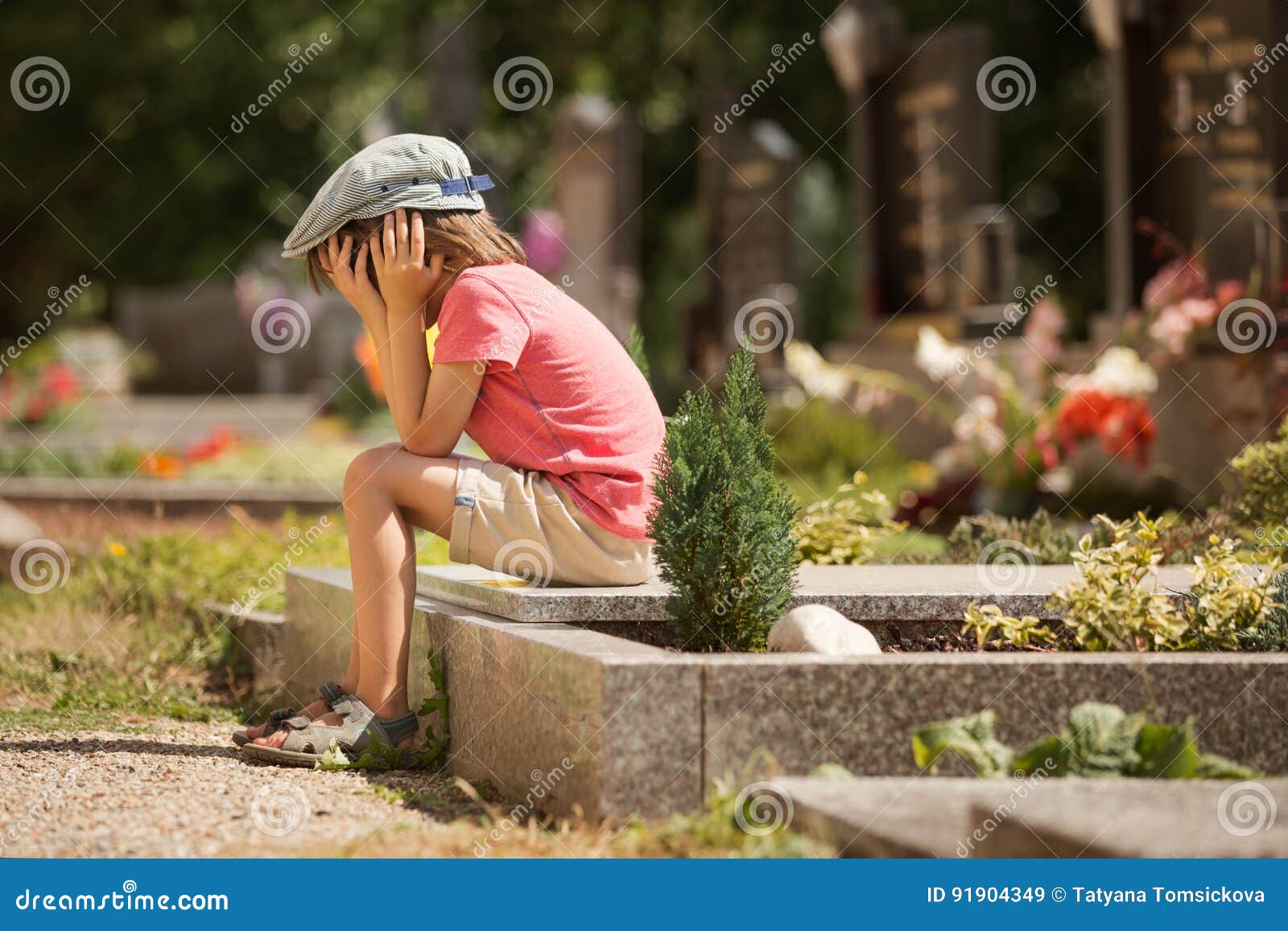 Sad Little Boy, Sitting on a Grave in a Cemetery, Feeling Sad Stock ...